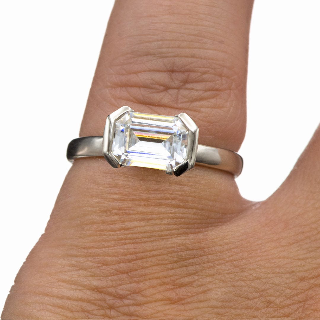 Sideways Emerald Cut Moissanite Ring Half Bezel Hannah Solitaire Engag ...